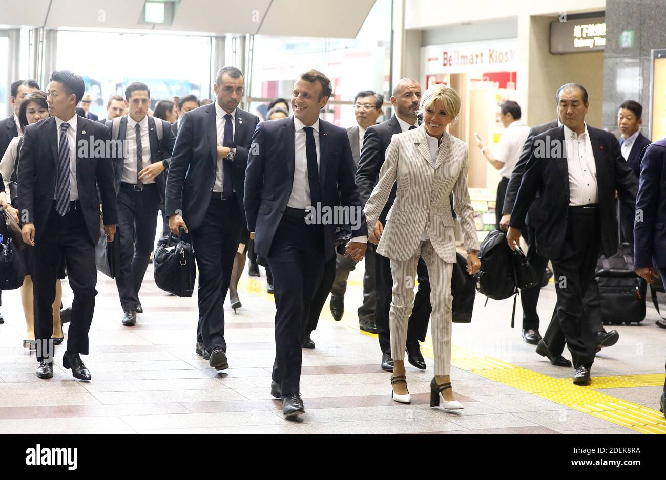 French President Emmanuel Macron and his wife Brigitte Macron walking ...