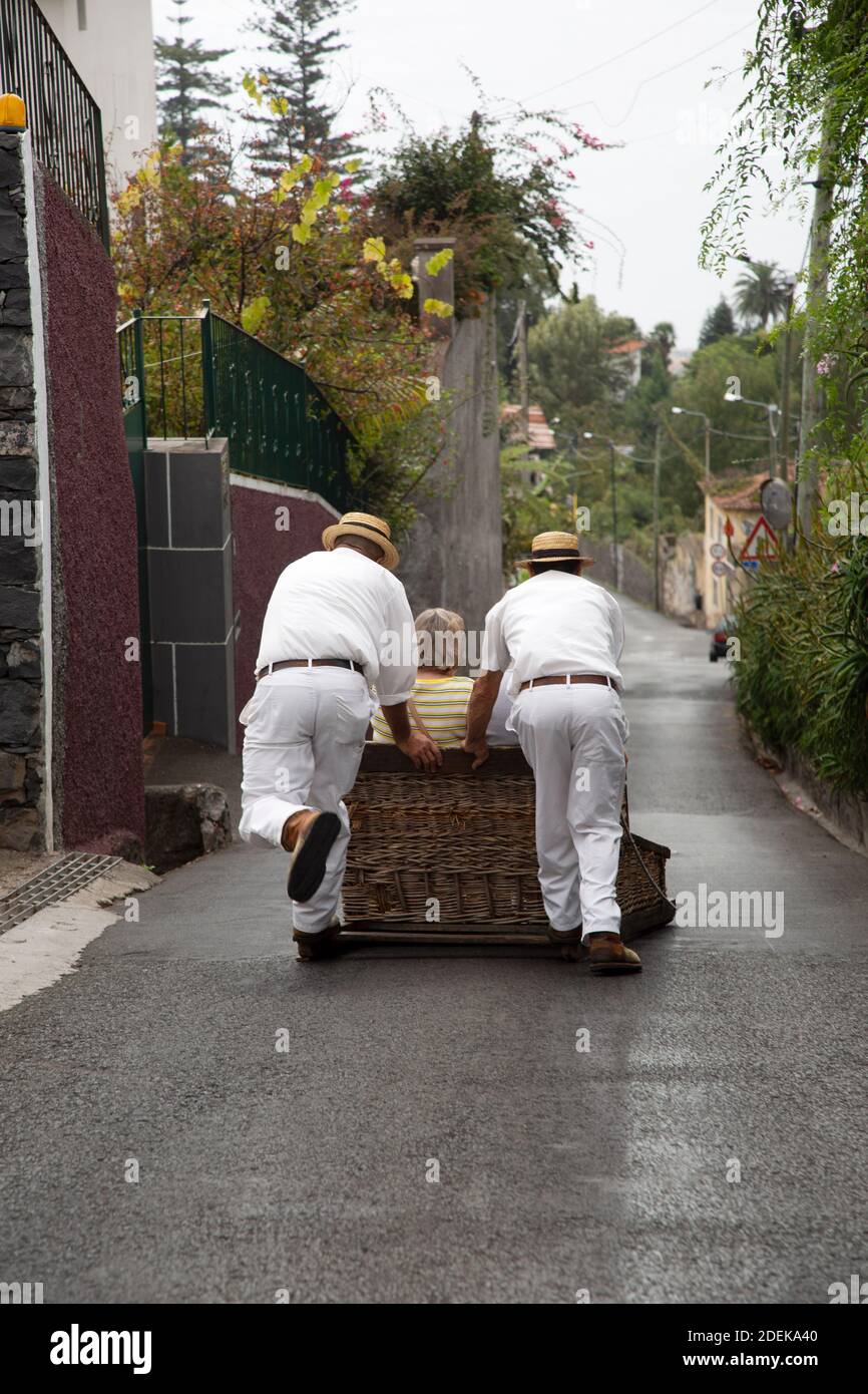 Carreiros Do Monte push wicker sleds down the hill in Funchal, Madeira ...