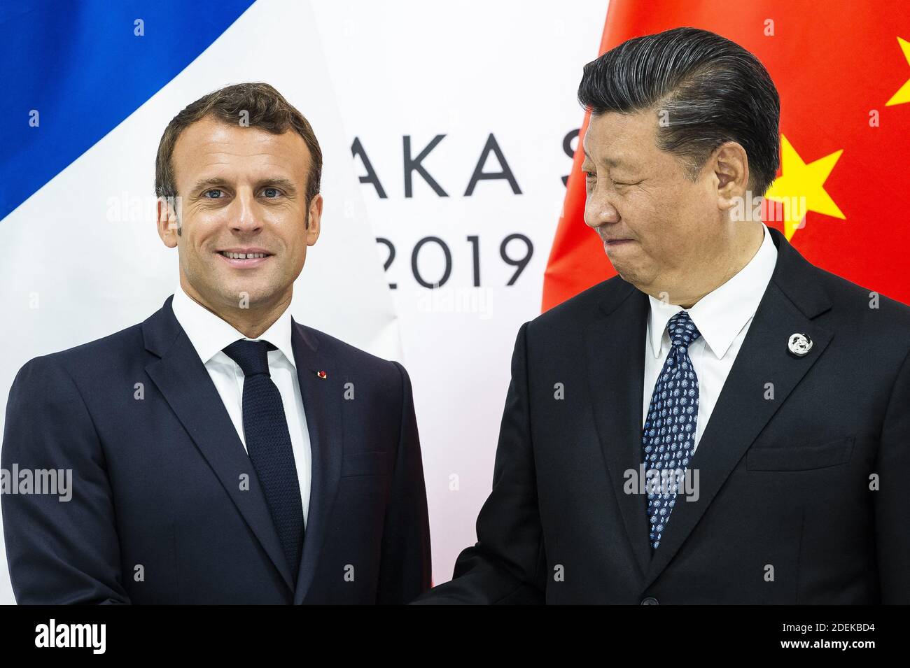 France's President Emmanuel Macron (L) shakes hands with China's ...