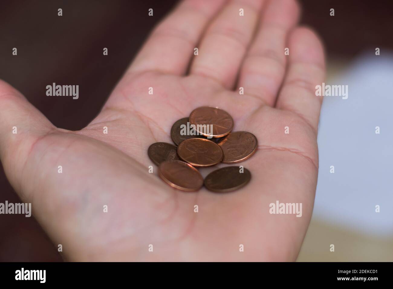 Persons hand holding out a a handful of United States of America (USA ...