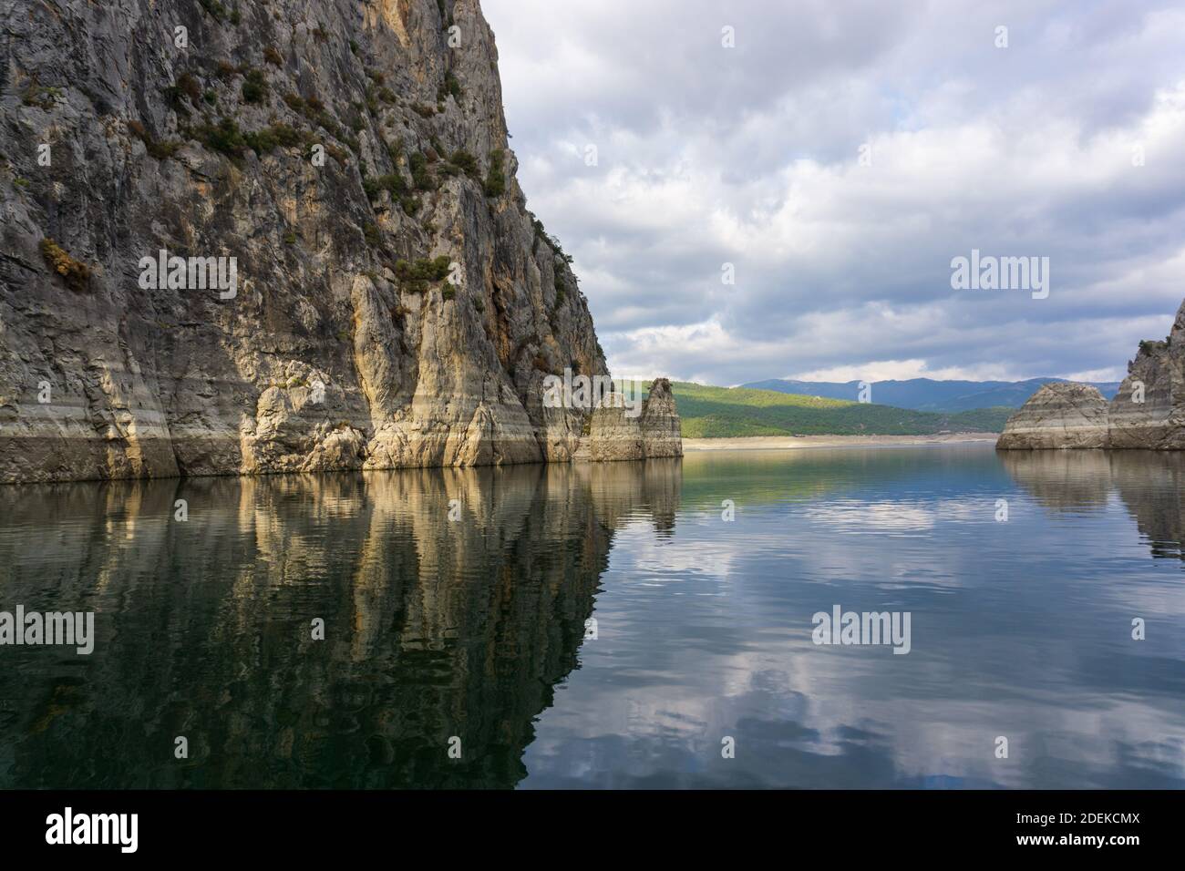 Reflection of rocks in water on a cloudy day Stock Photo - Alamy