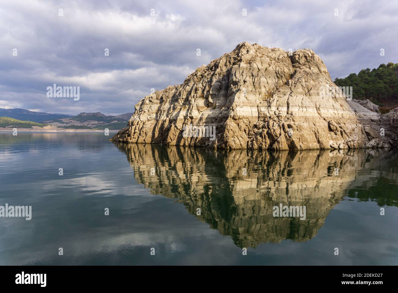 Reflection of rocks in water on a cloudy day Stock Photo - Alamy