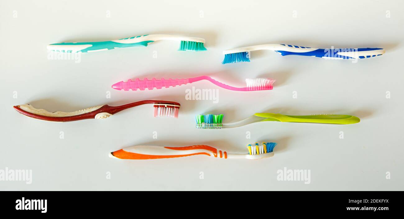 Used plastic toothbrushes on a white background. Ecology and waste ...