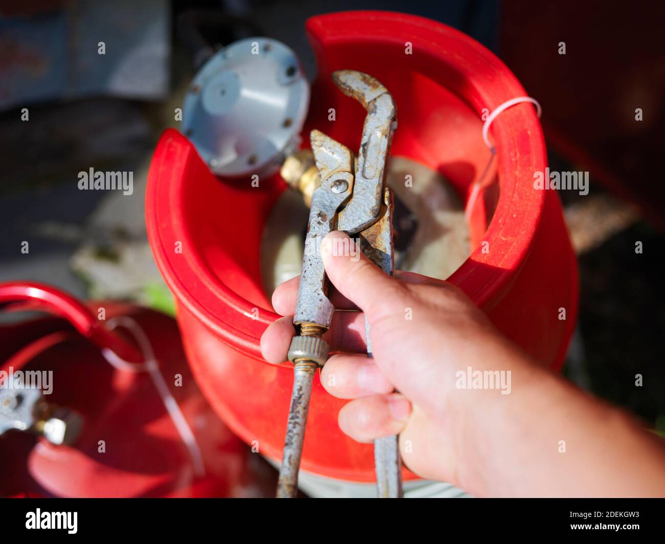 Closeup of a hand with wrench tightening a gas bottle cap Stock Photo ...