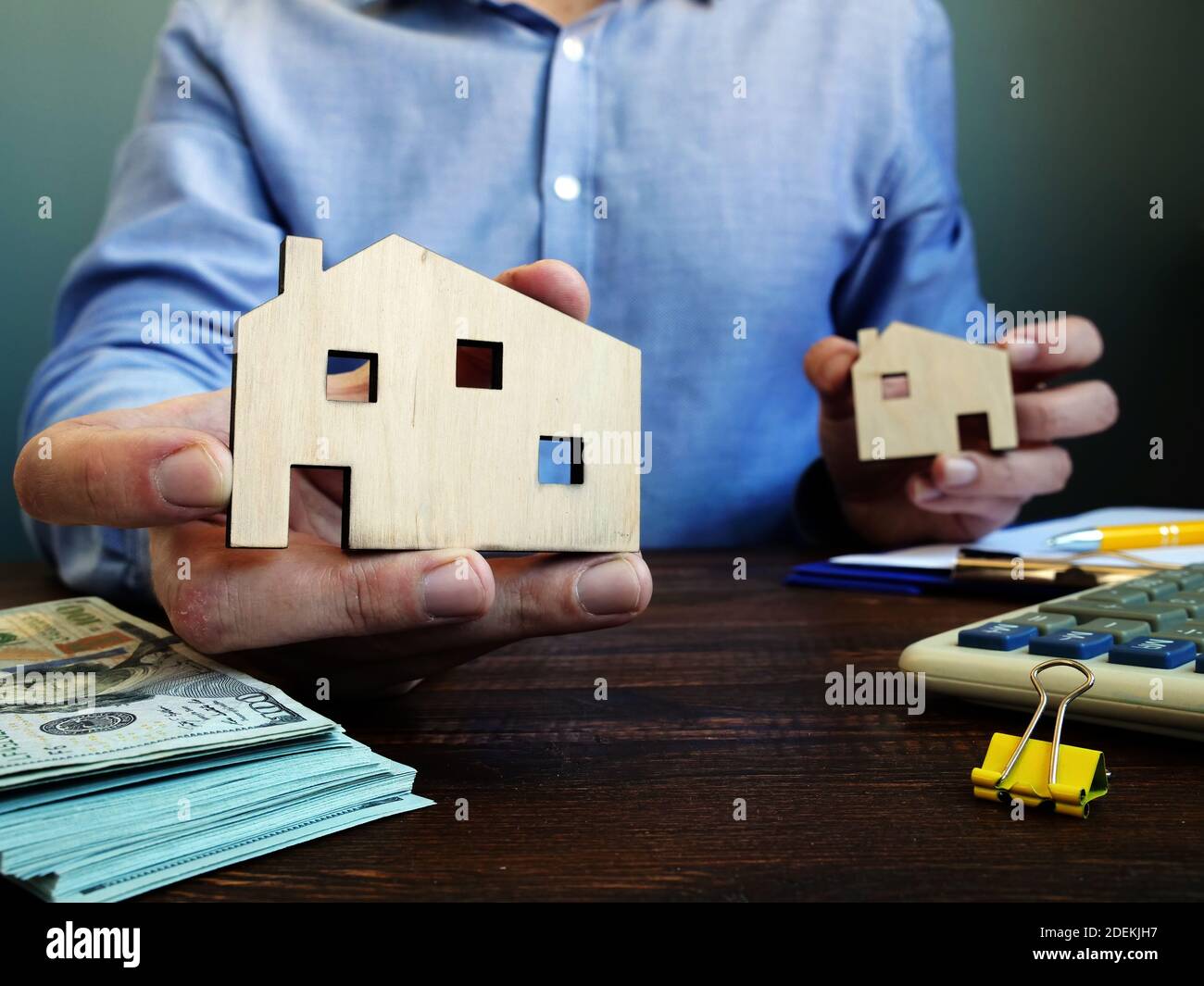 The realtor offers to choose a house. Property search Stock Photo - Alamy