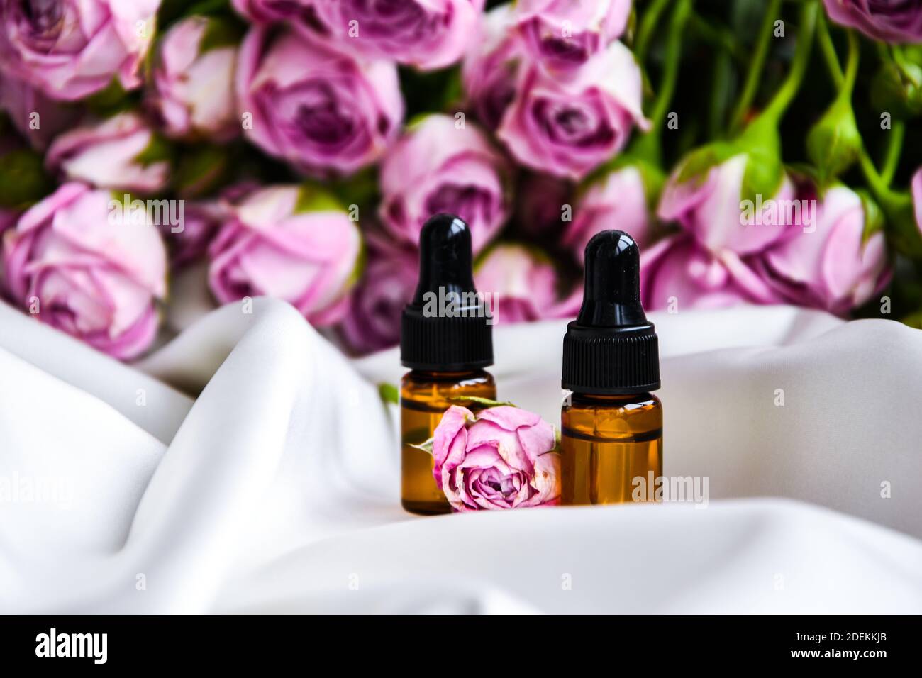 Rose oil. Spa and aromatherapy rose flowers essential oil bottle with ...