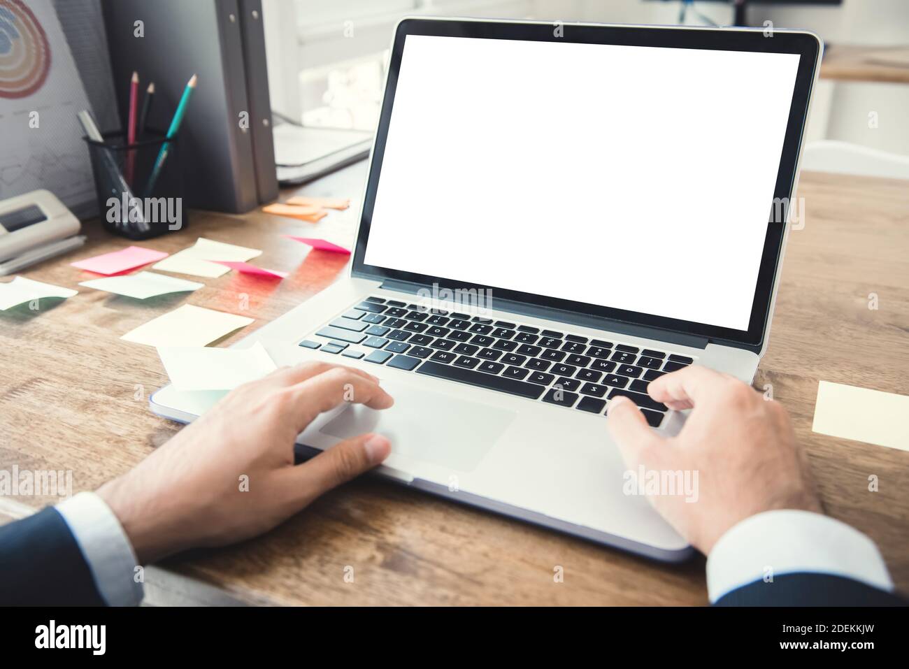 Laptop computer with blank empty screen being used by a businessman at ...