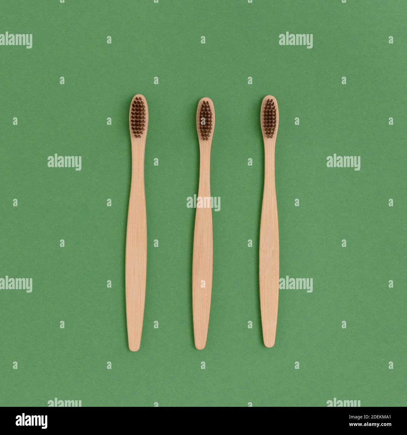 Layout of toothbrushes on a green background. Plastic free concept ...