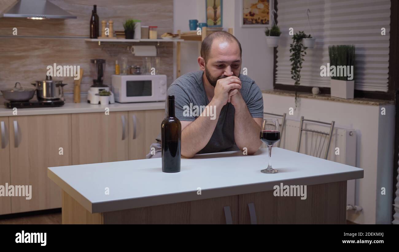 Sad husband drinking in kitchen hi-res stock photography and images - Alamy