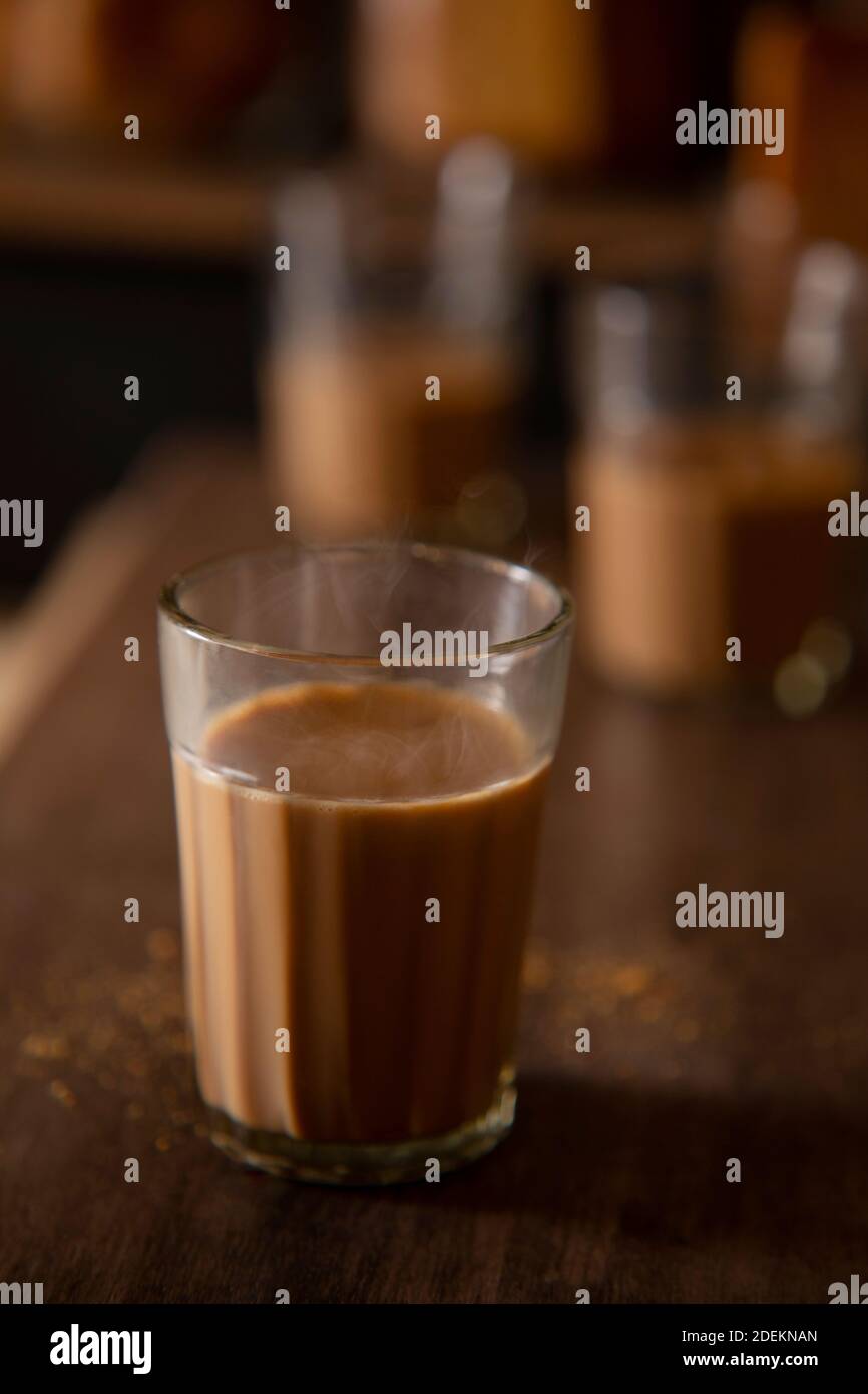 Close up of a glass half filled with tea kept on table Stock Photo - Alamy