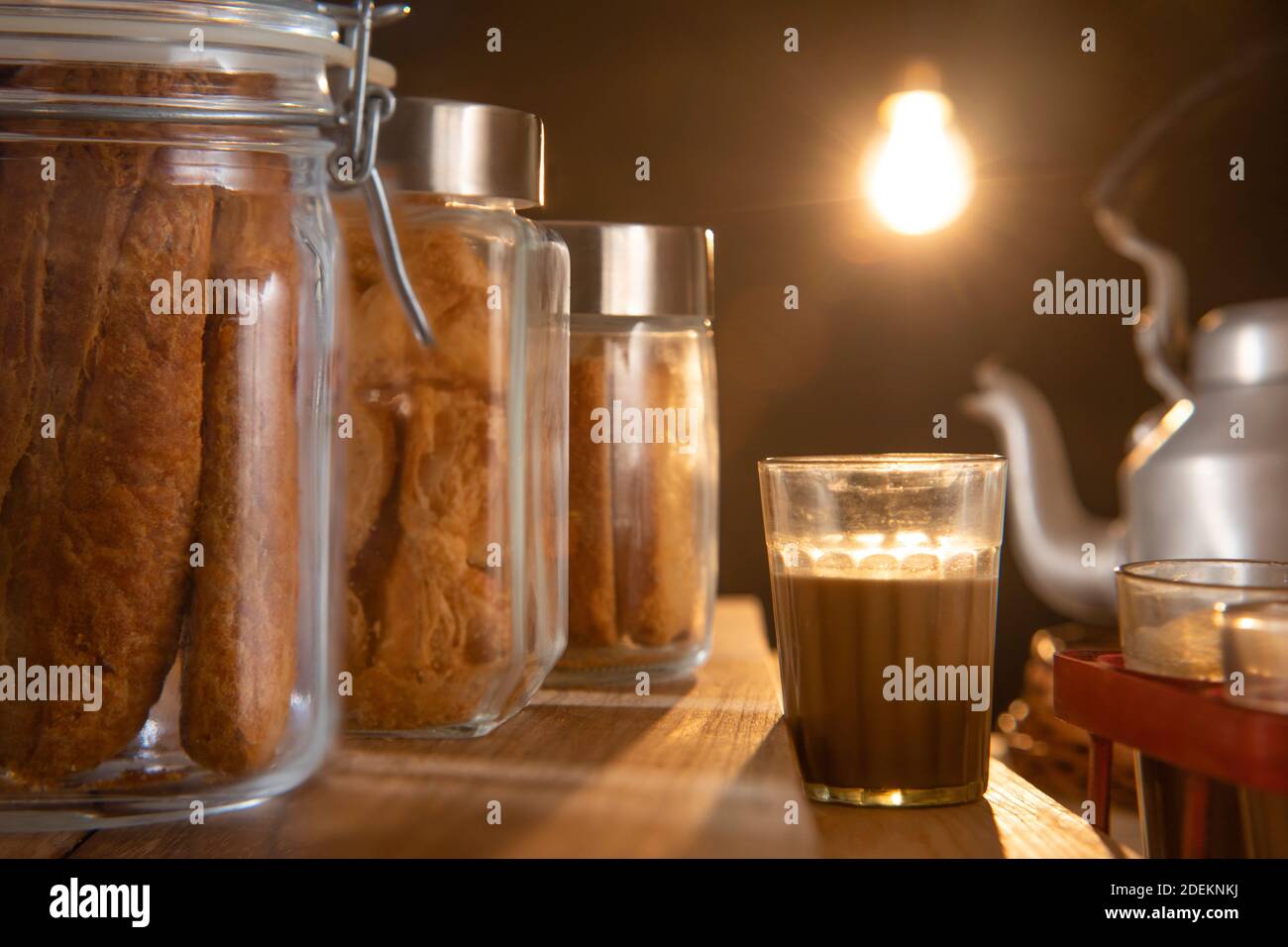 Jars of fan, matthi and rusk kept with tea glass and kettle in a tea ...