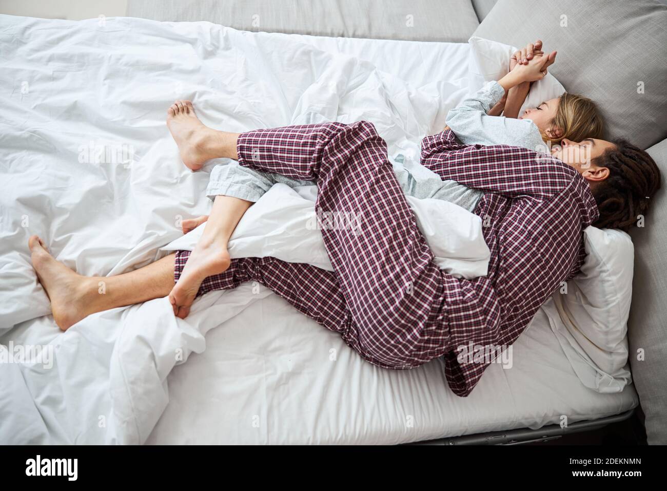 Beautiful couple in love sleeping together in bed Stock Photo - Alamy