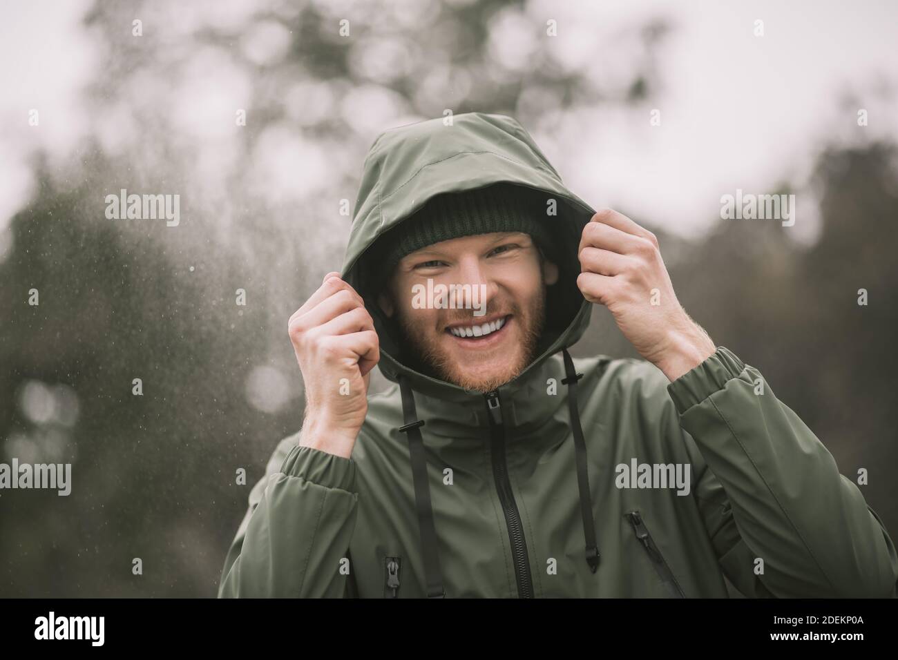 Close up picture of a young man in a green coat Stock Photo - Alamy
