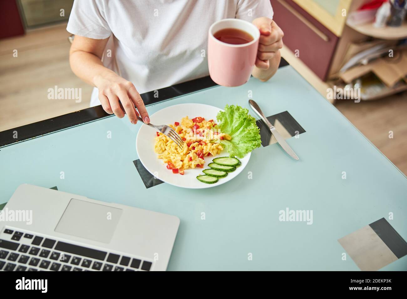 Female poking an omelet with a fork while having tea Stock Photo - Alamy