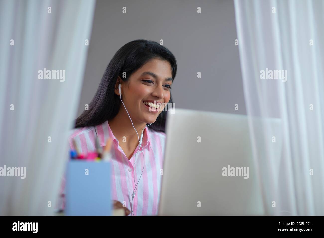 Woman attending office meeting while working from home during lockdown ...