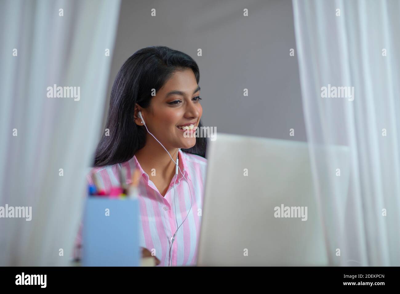 Woman attending office meeting while working from home during lockdown ...