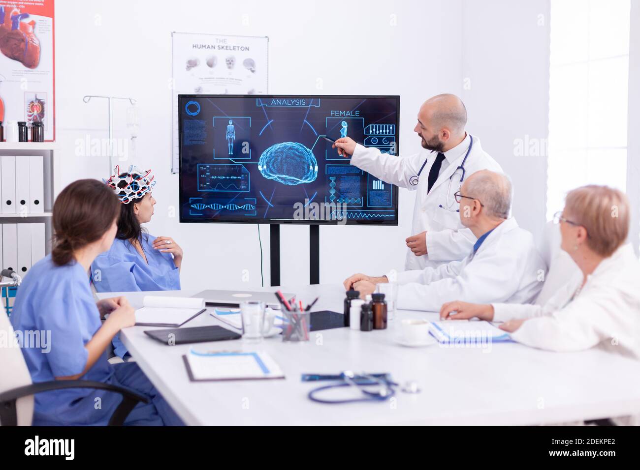 Team of doctors doing research about brain activity using headset with ...