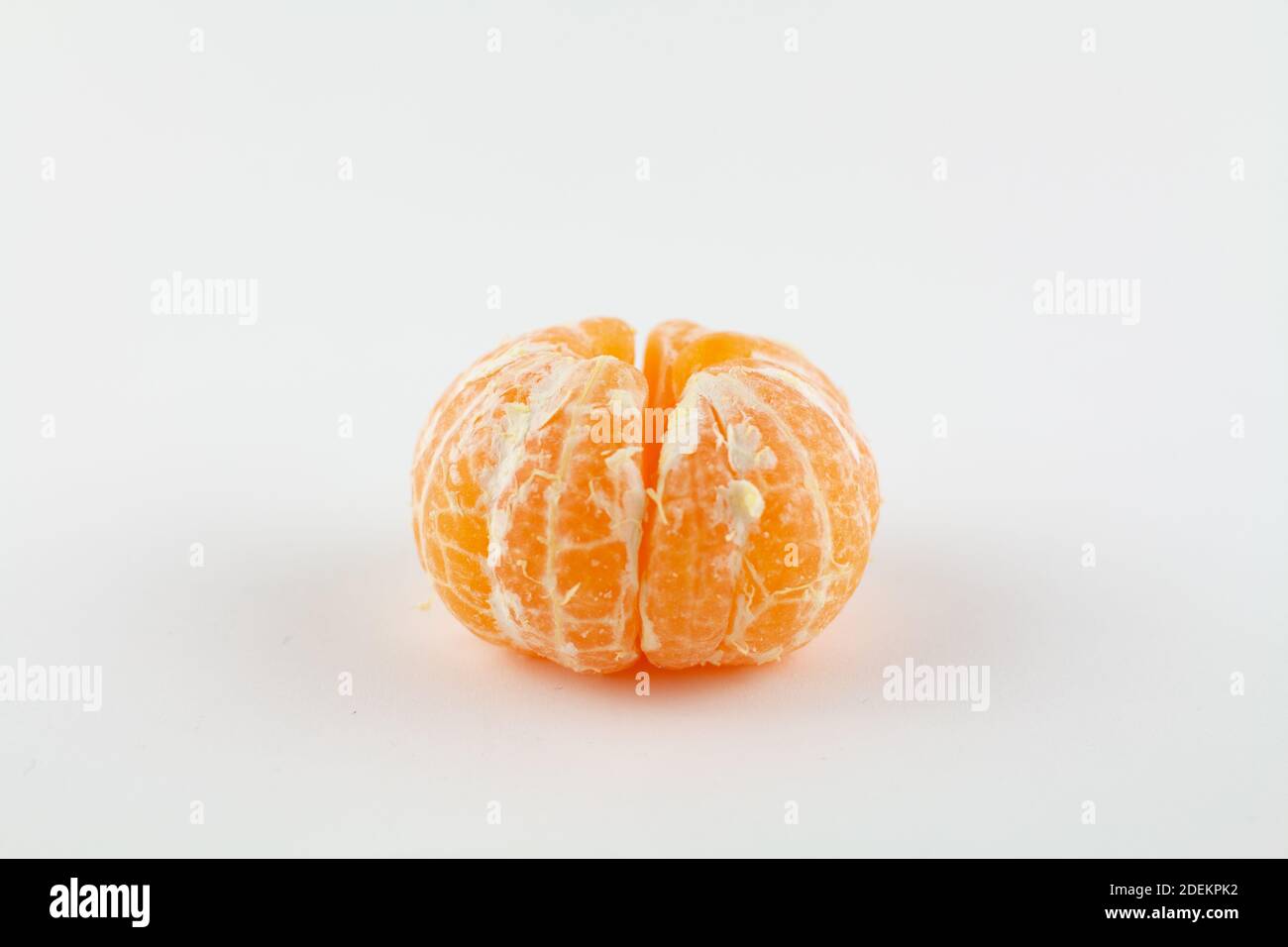 a beautiful ripe peeled tangerine on a white background Stock Photo - Alamy