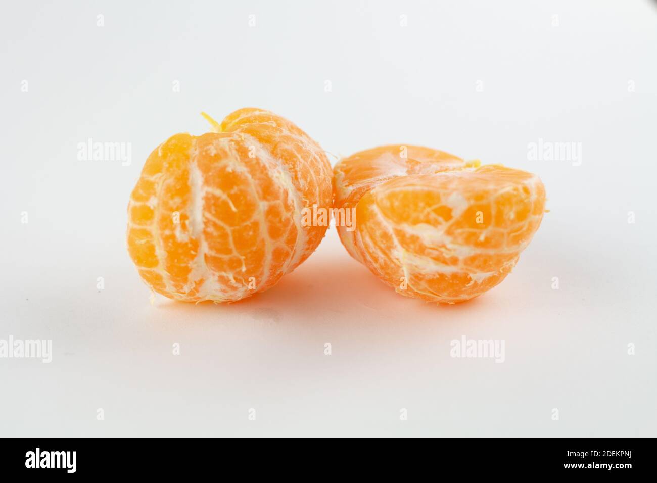 a beautiful ripe peeled tangerine on a white background Stock Photo - Alamy