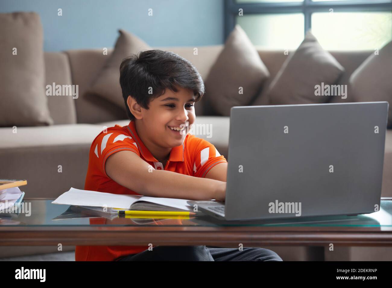 YOUNG KID ATTENDING HIS ONLINE CLASS IN ENTHUSIASM Stock Photo - Alamy