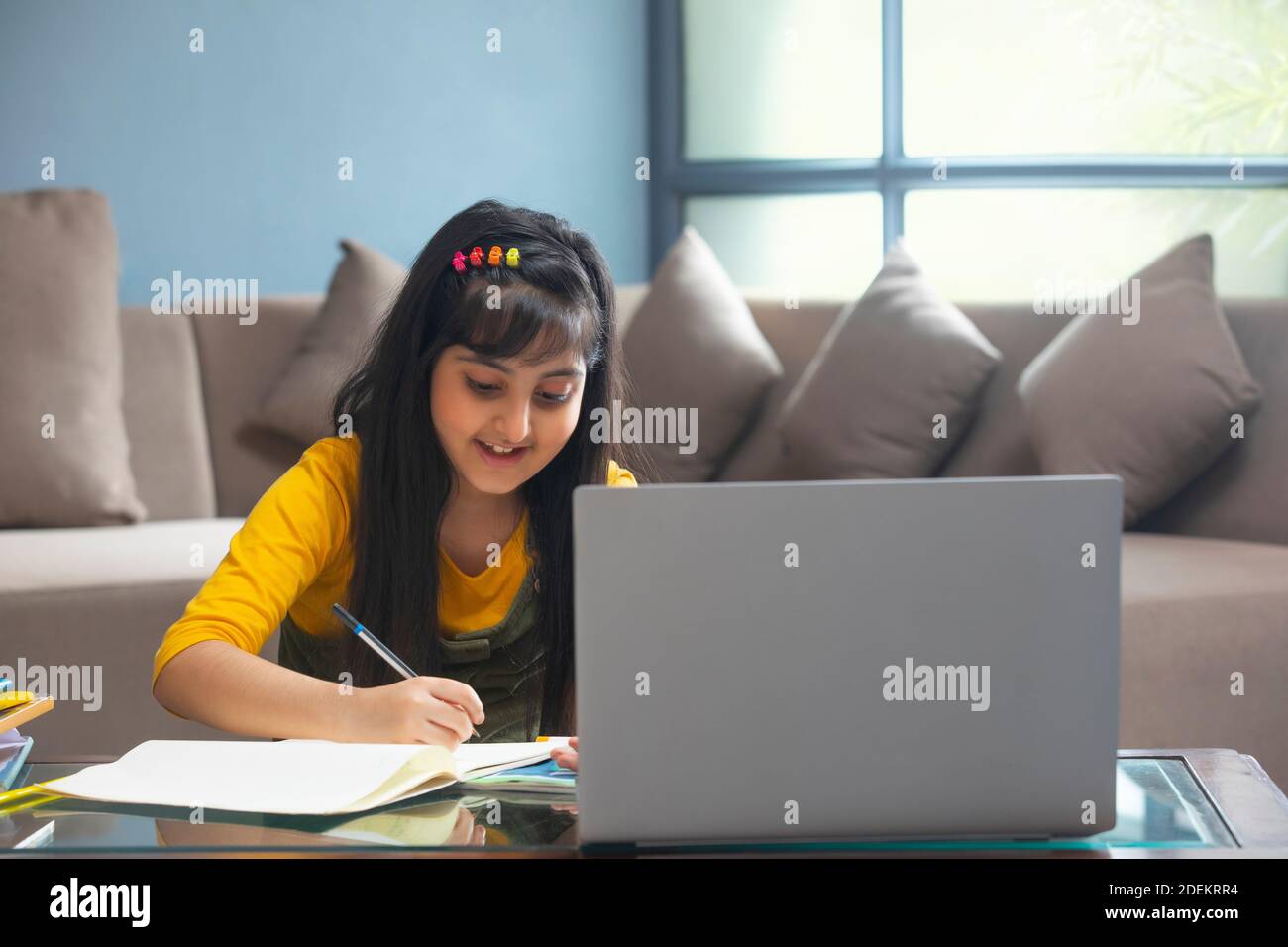Indian girl writing in notebook hi-res stock photography and images - Alamy