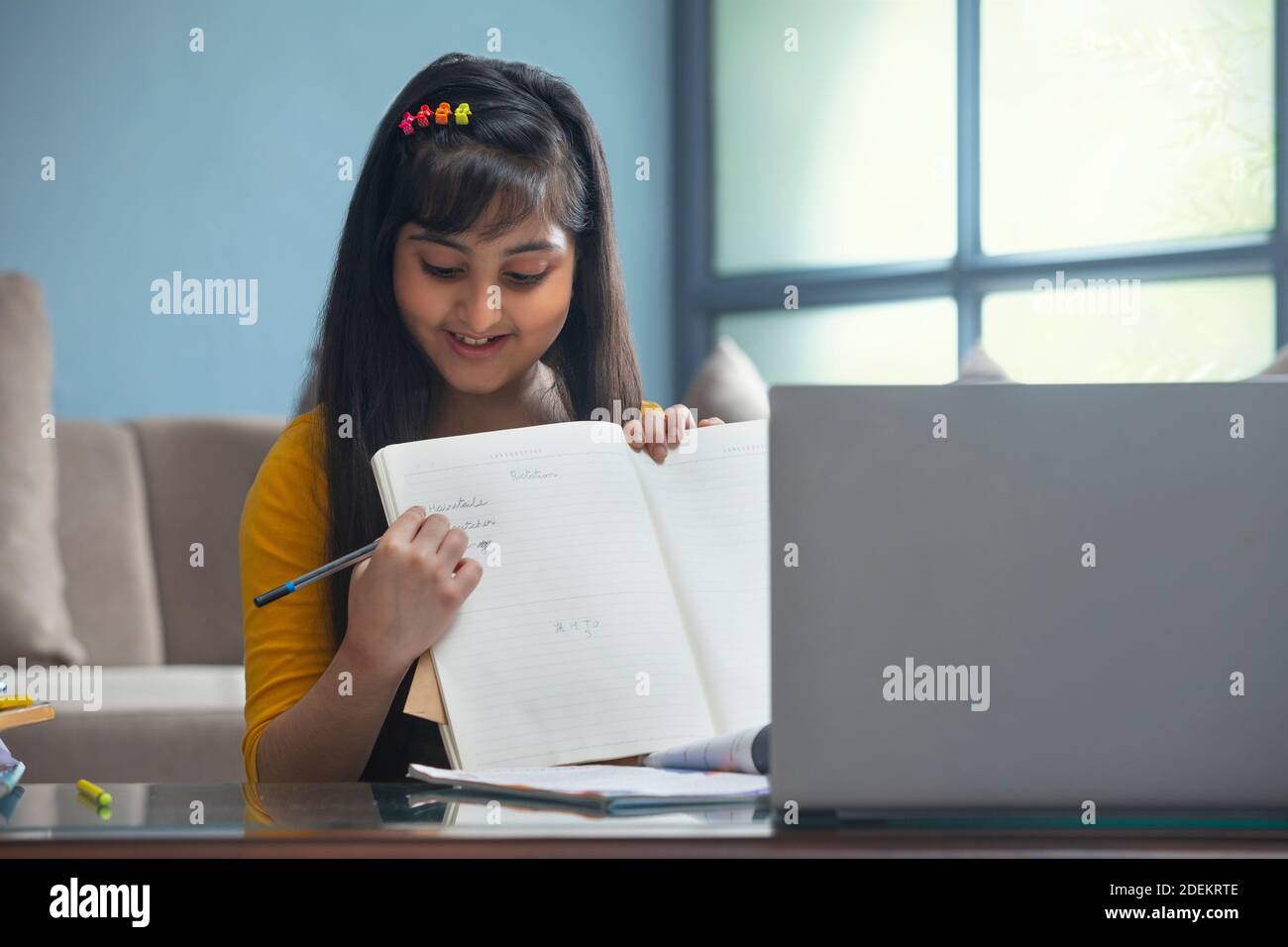 Young girl showing the spellings of the words her teacher dictated in ...