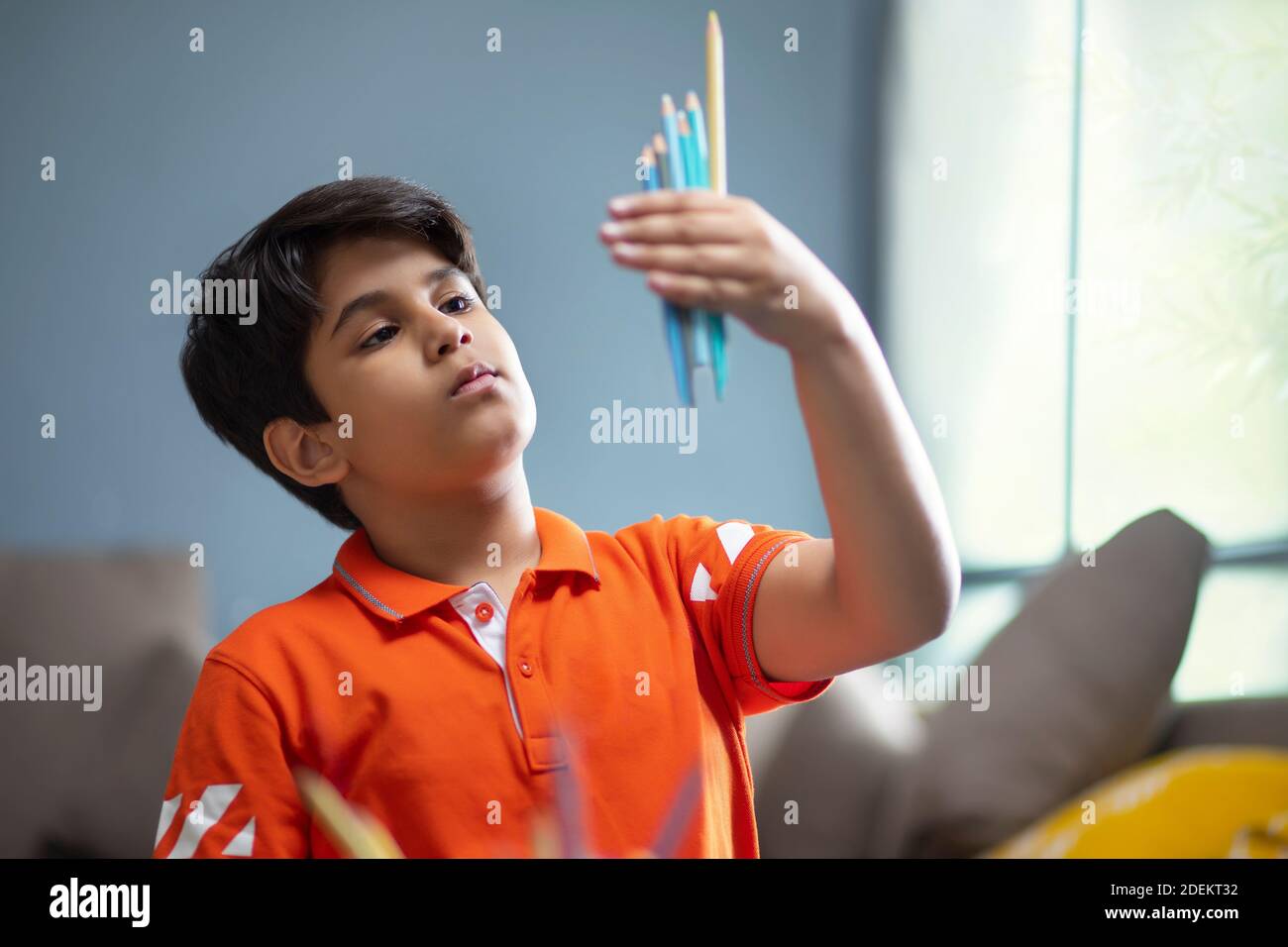 Young boy trying to decide the perfect color for drawing Stock Photo ...
