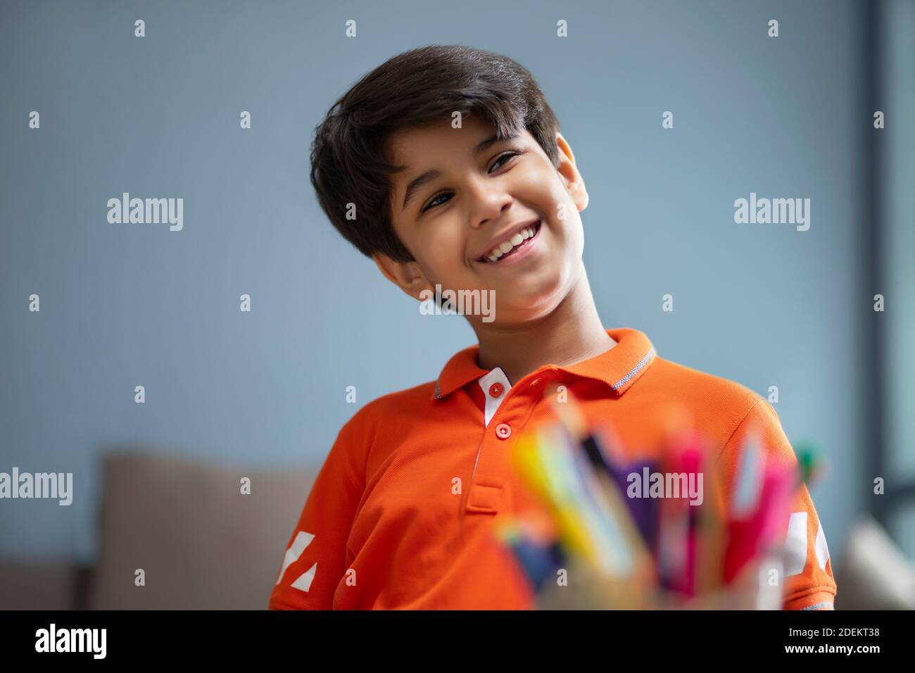 Young boy looking sideways with a smile on his face Stock Photo - Alamy