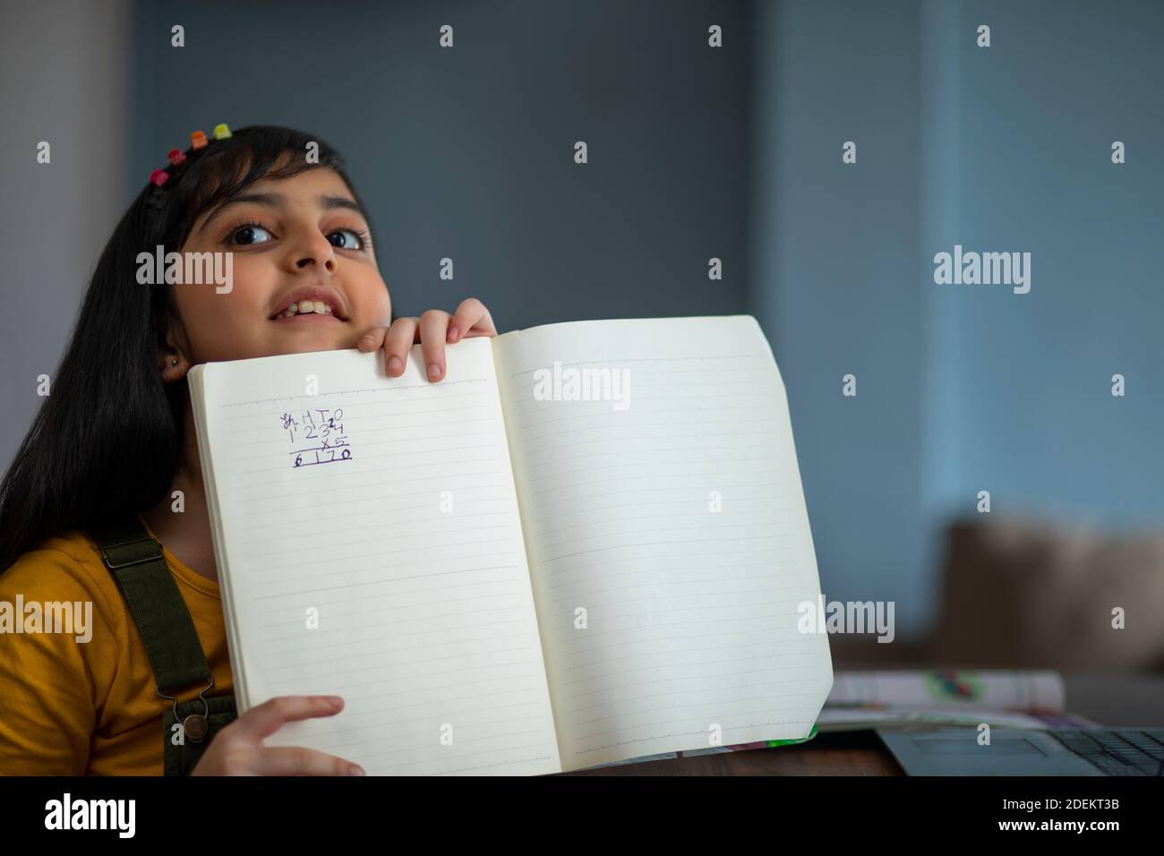 Girl showing a math sum she solved in the notebook Stock Photo - Alamy