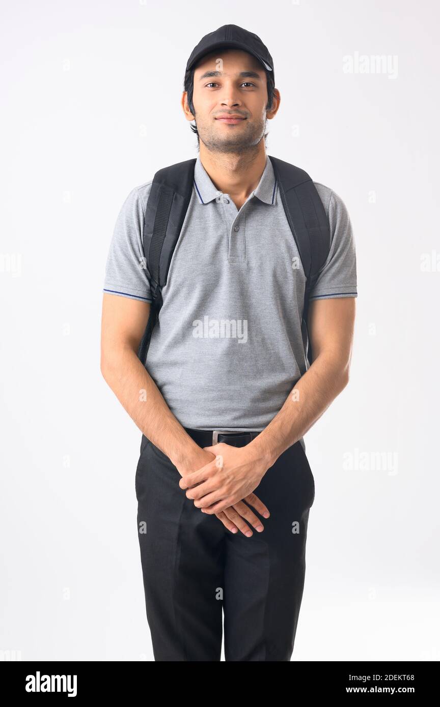 Delivery boy in his uniform standing with a bag pack Stock Photo - Alamy