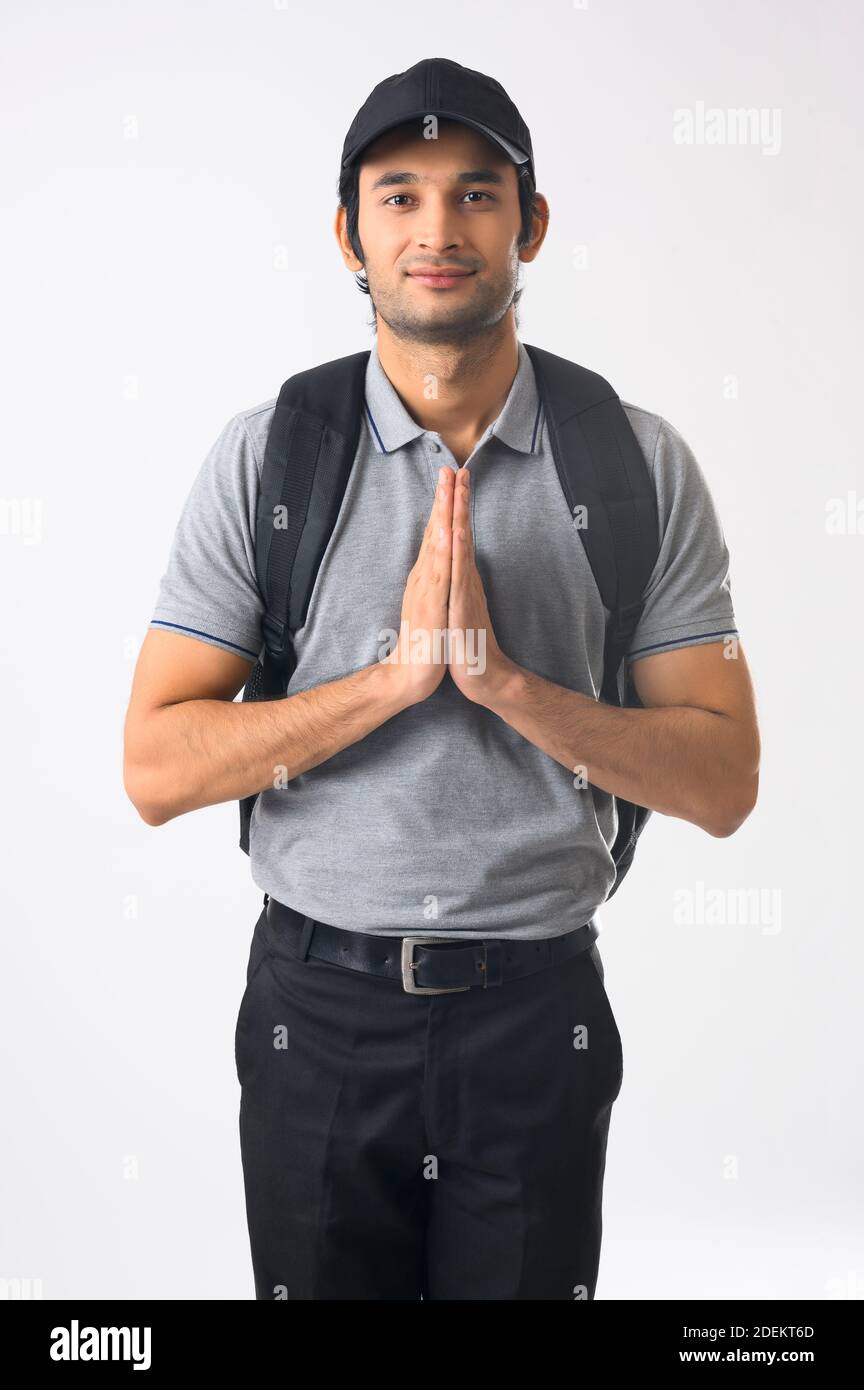 Young delivery boy with a bag pack greeting with a smile Stock Photo ...