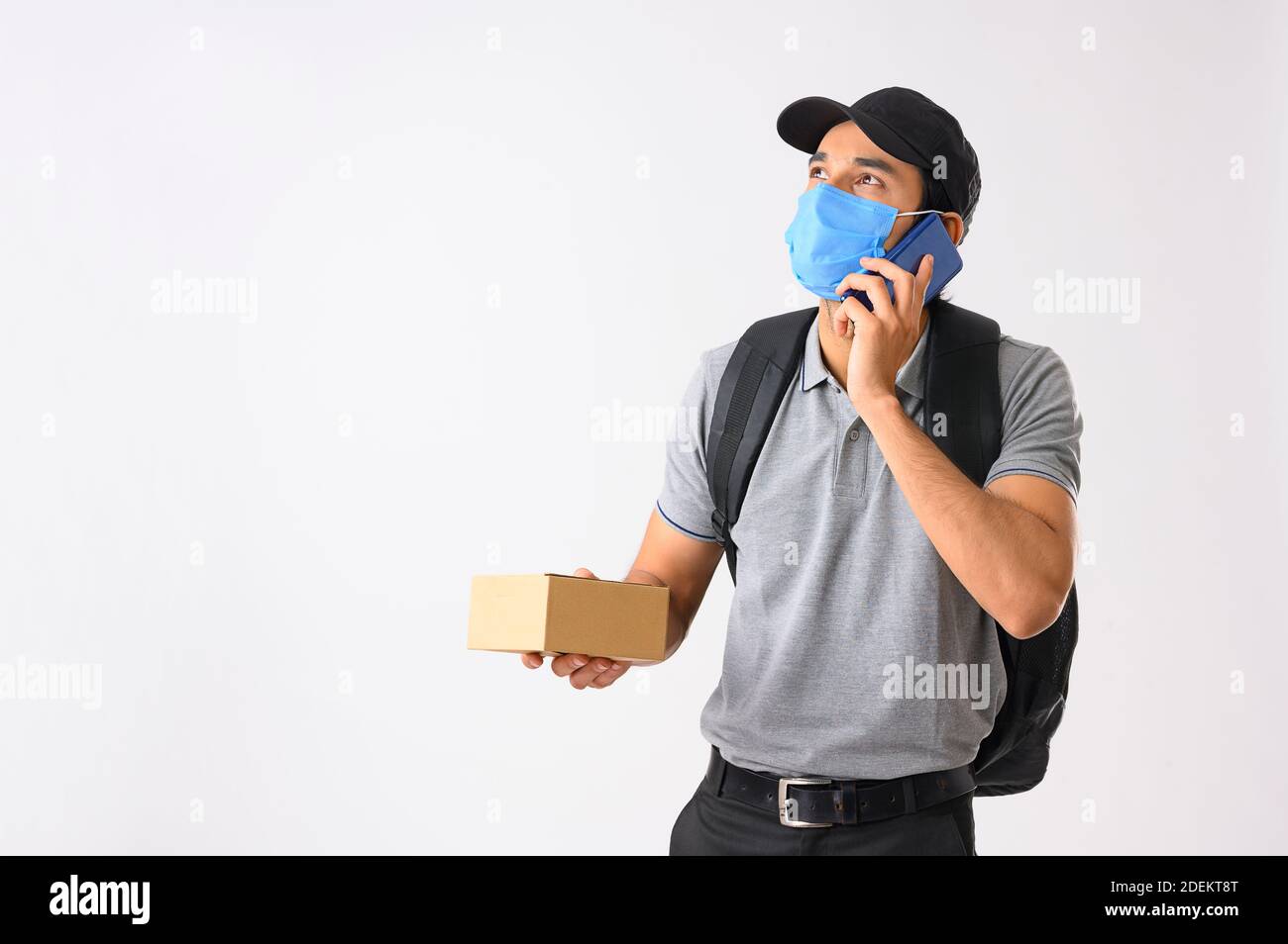 Courier boy taking instructions for delivering the package on call ...