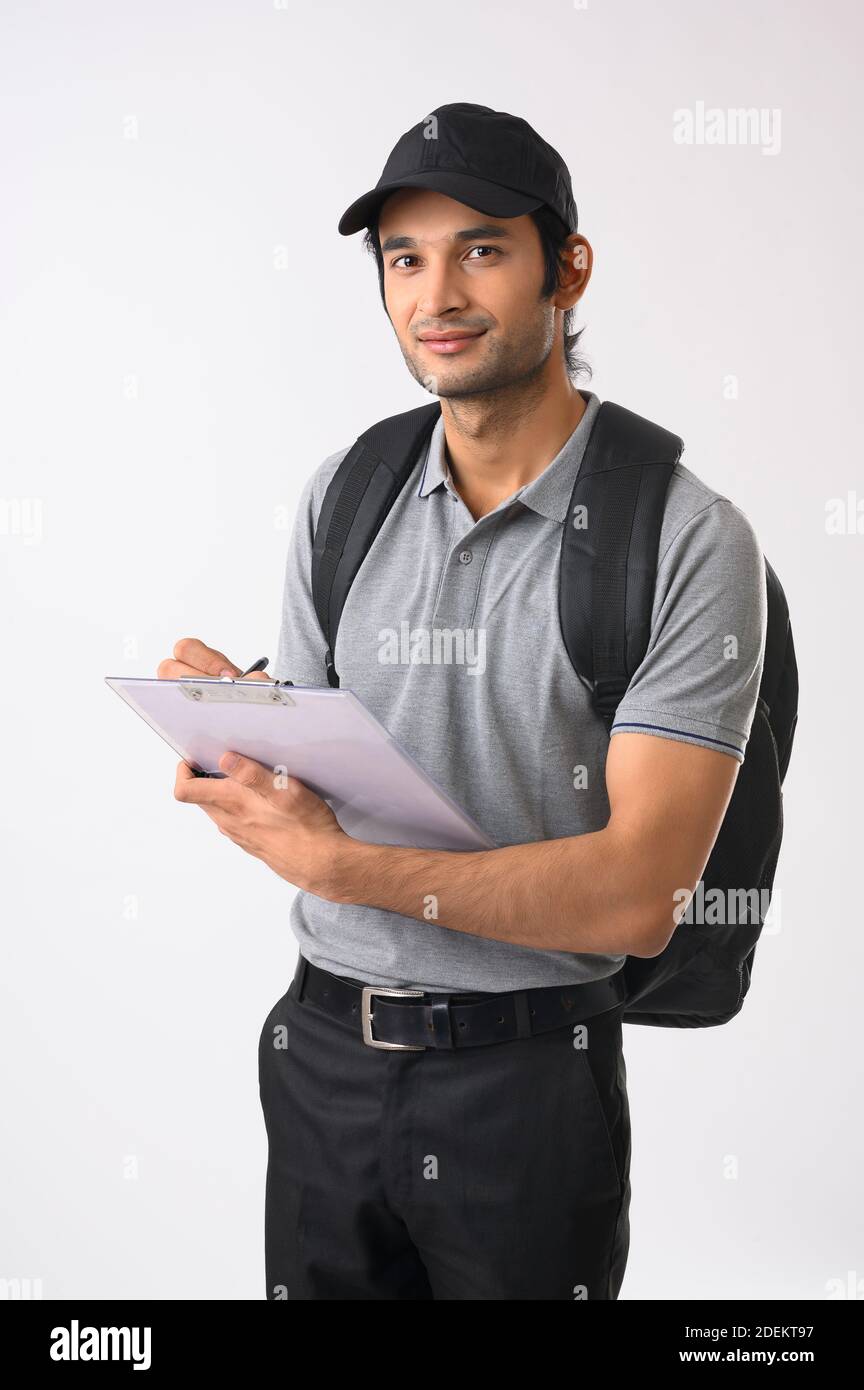 Courier boy writing the details after delivering the parcel Stock Photo ...