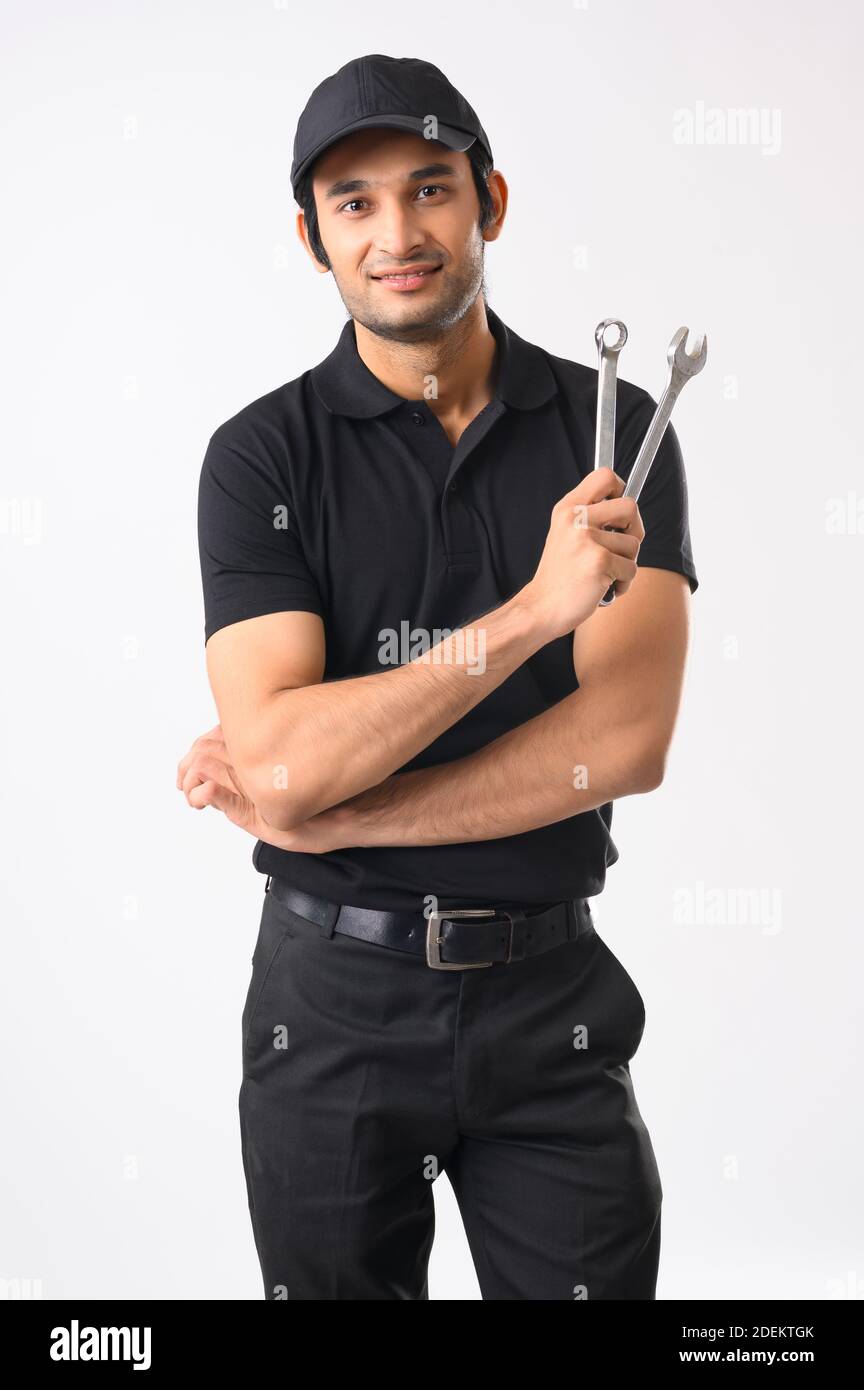 Mechanic in his uniform holding a spanner in his hand Stock Photo - Alamy