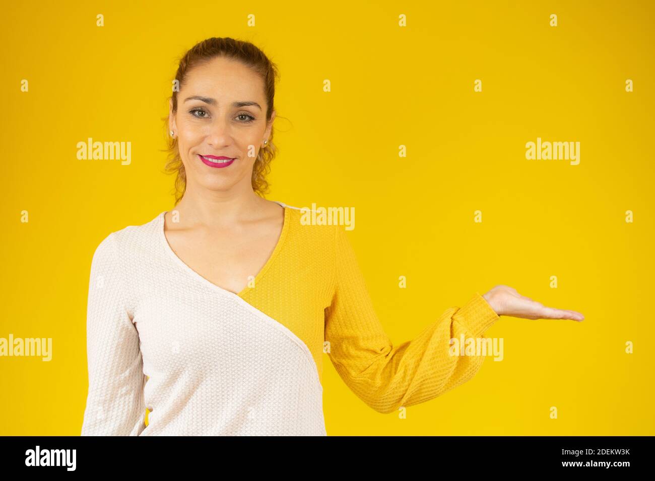 Woman smiles surprise showing product. Presenting your advertisement ...