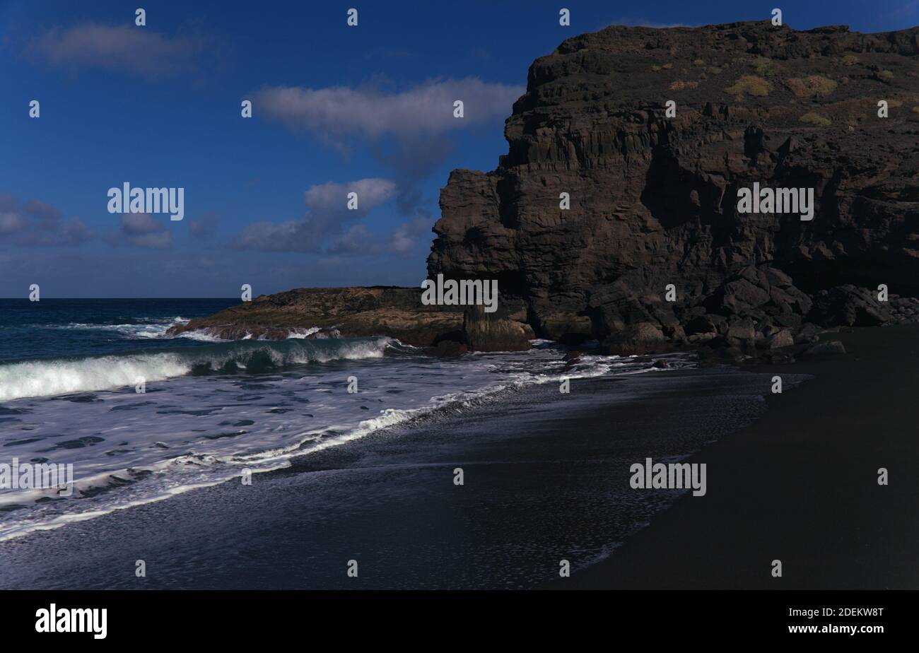 Gran Canaria, dark volcanic sand beach Playa de Guayedra in Agaete ...