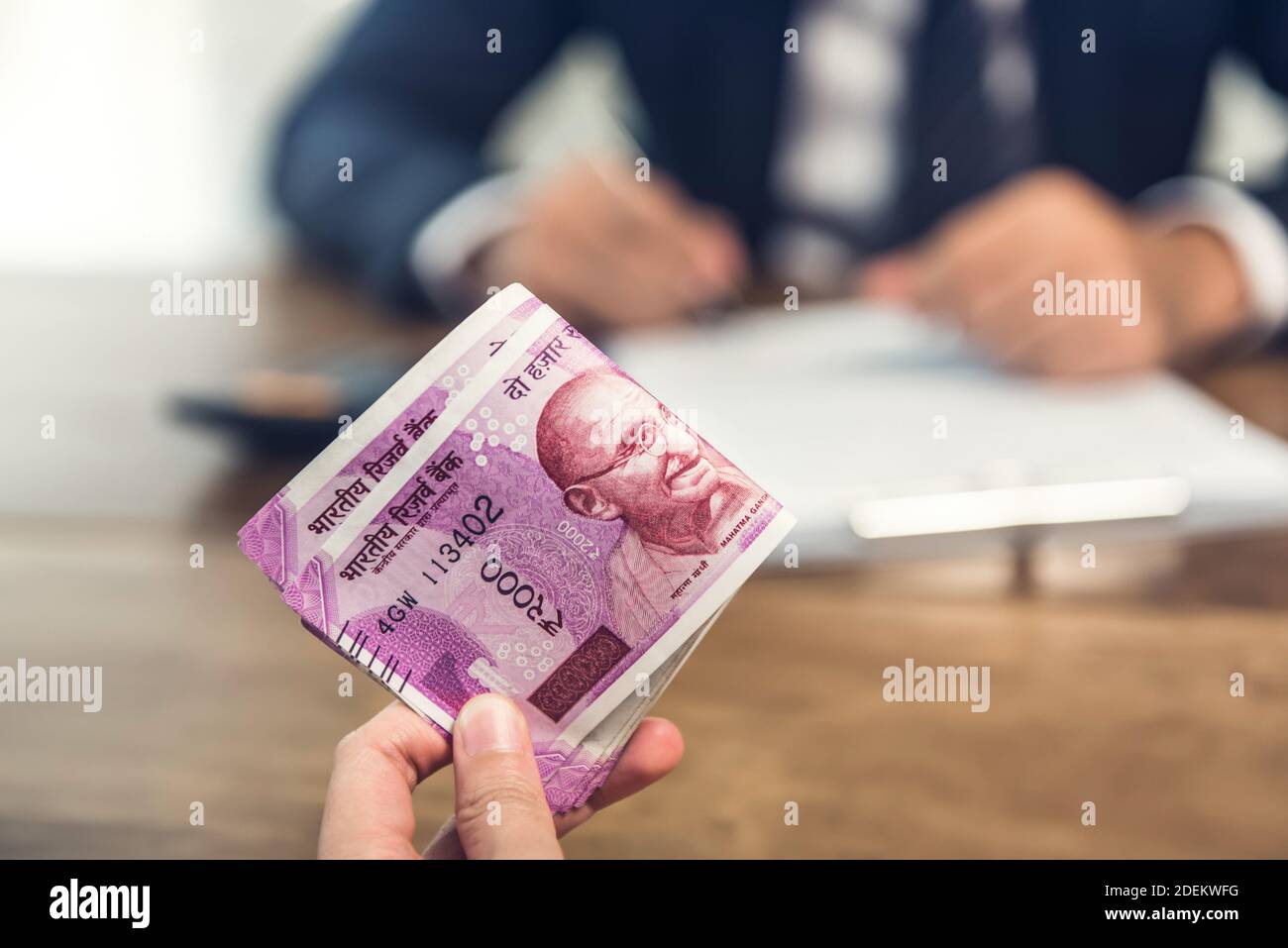 Businessman giving money in the form of Indian Rupees for service ...