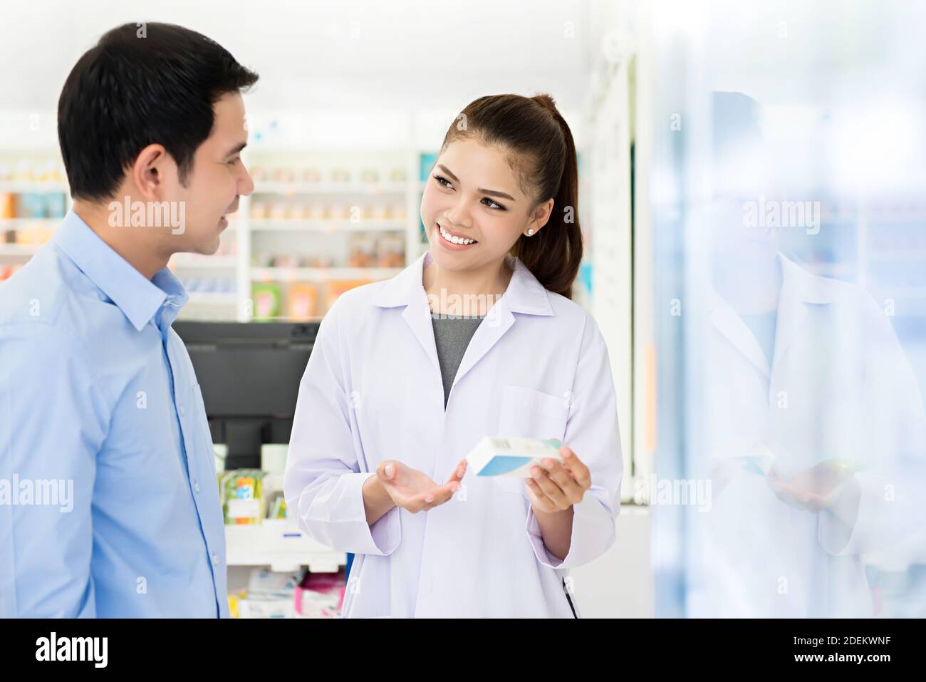 Beautiful Asian female pharmacist or doctor explaining prescription ...