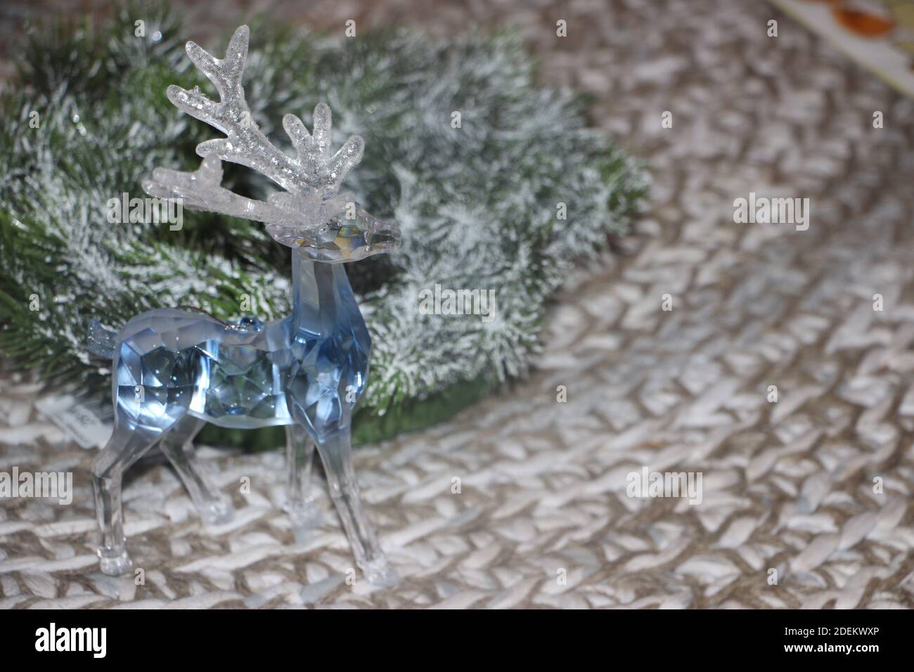 Crystal reindeer statuette in front of colorful Aurora with reflections ...