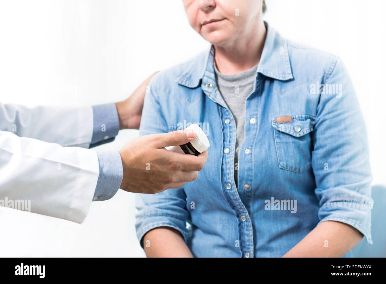 Doctor introducing and explaining the medicine to senior woman patient ...