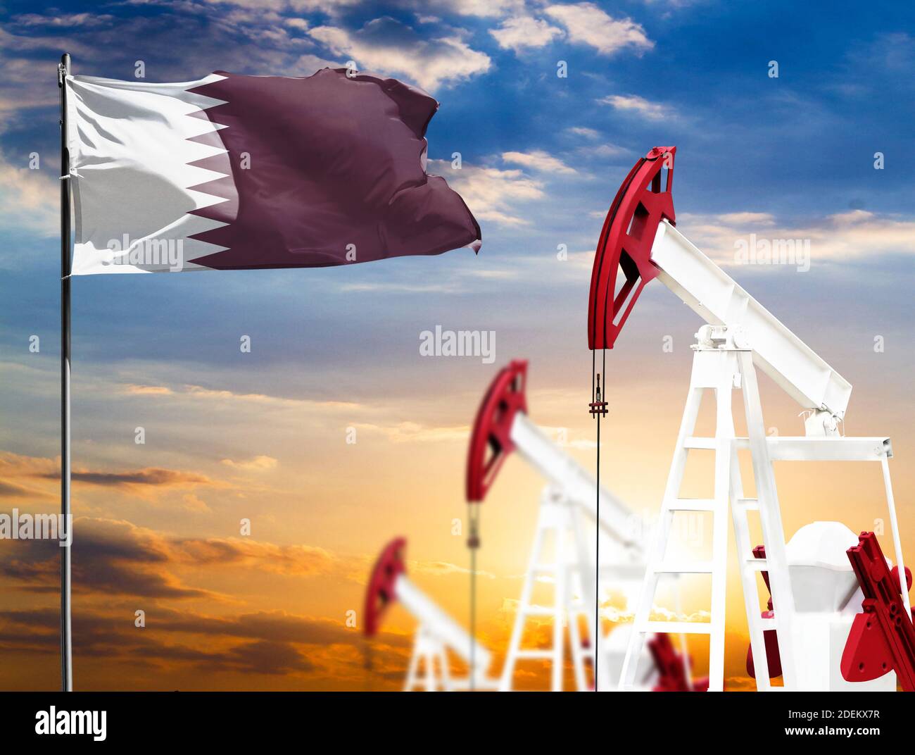 Oil rigs against the backdrop of the colorful sky and a flagpole with ...
