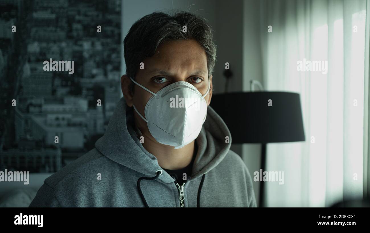 A man wearing a mask in confinament Stock Photo - Alamy