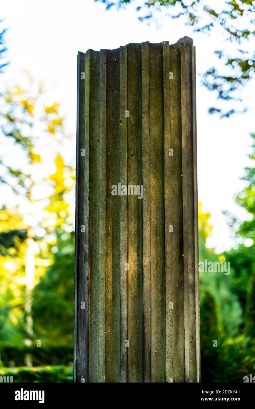 Broken old Greek stone pillar in a park. Symbol of power and authority ...