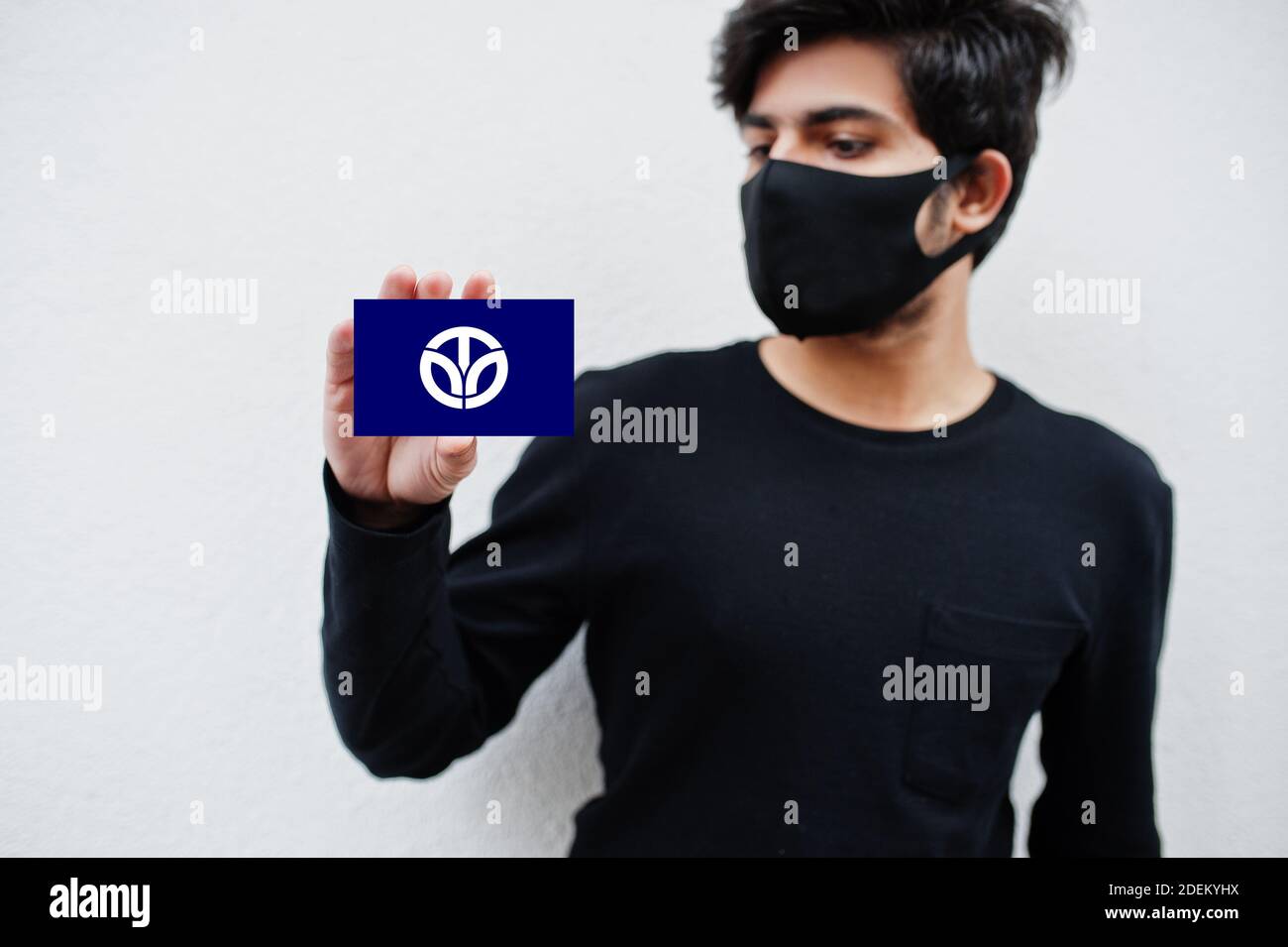 Japanese man wear all black with face mask hold Fukui flag in hand ...