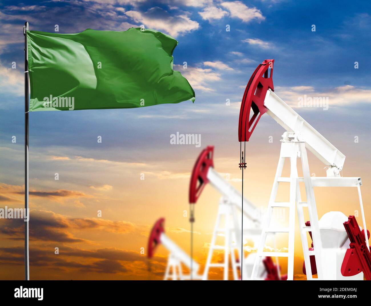 Oil rigs against the backdrop of the colorful sky and a flagpole with ...