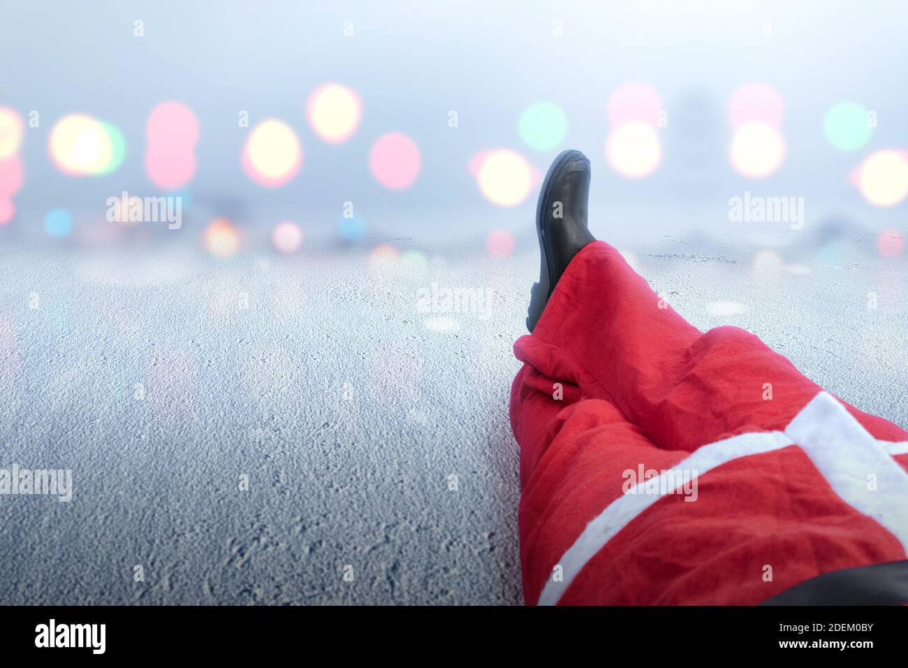 Santa Claus lying on the snow with blurred light background. Merry ...