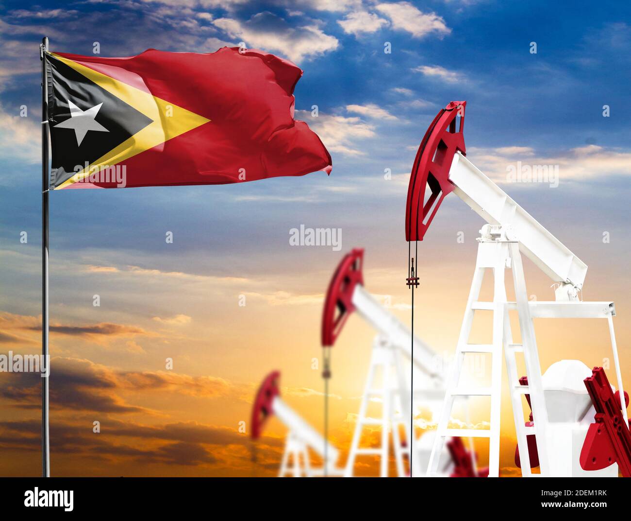 Oil rigs against the backdrop of the colorful sky and a flagpole with ...