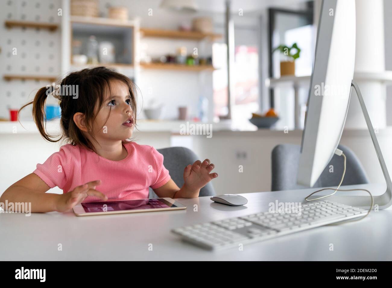 Little addicted child playing with technology devices at home Stock ...