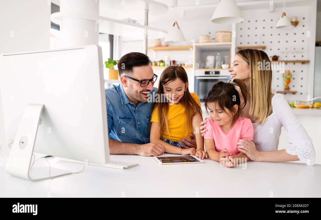 Online school, technology, family concept. Happy parents helping to ...