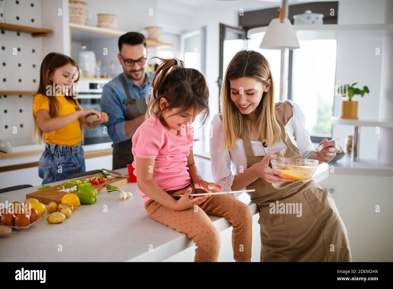 Happy family in the kitchen having fun and cooking together. Healthy ...